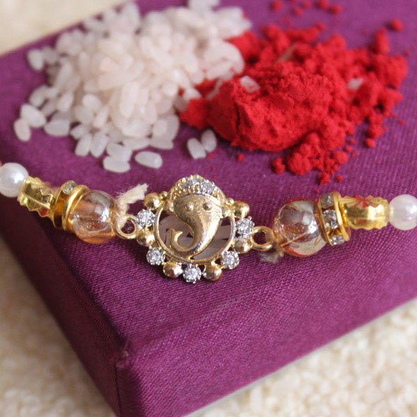 Send Golden Ganpati AD Stone Rakhi Online | Rakhibazaar.com
