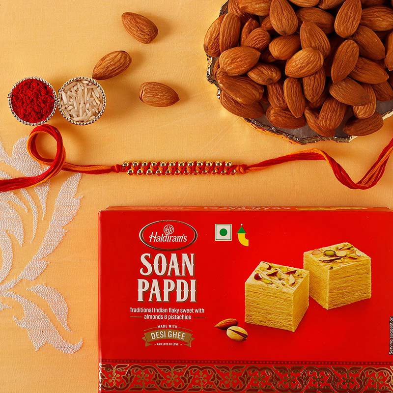 Send Sneh Gold Mauli Rakhi with 250 Grams Soan papdi and Almonds Online ...